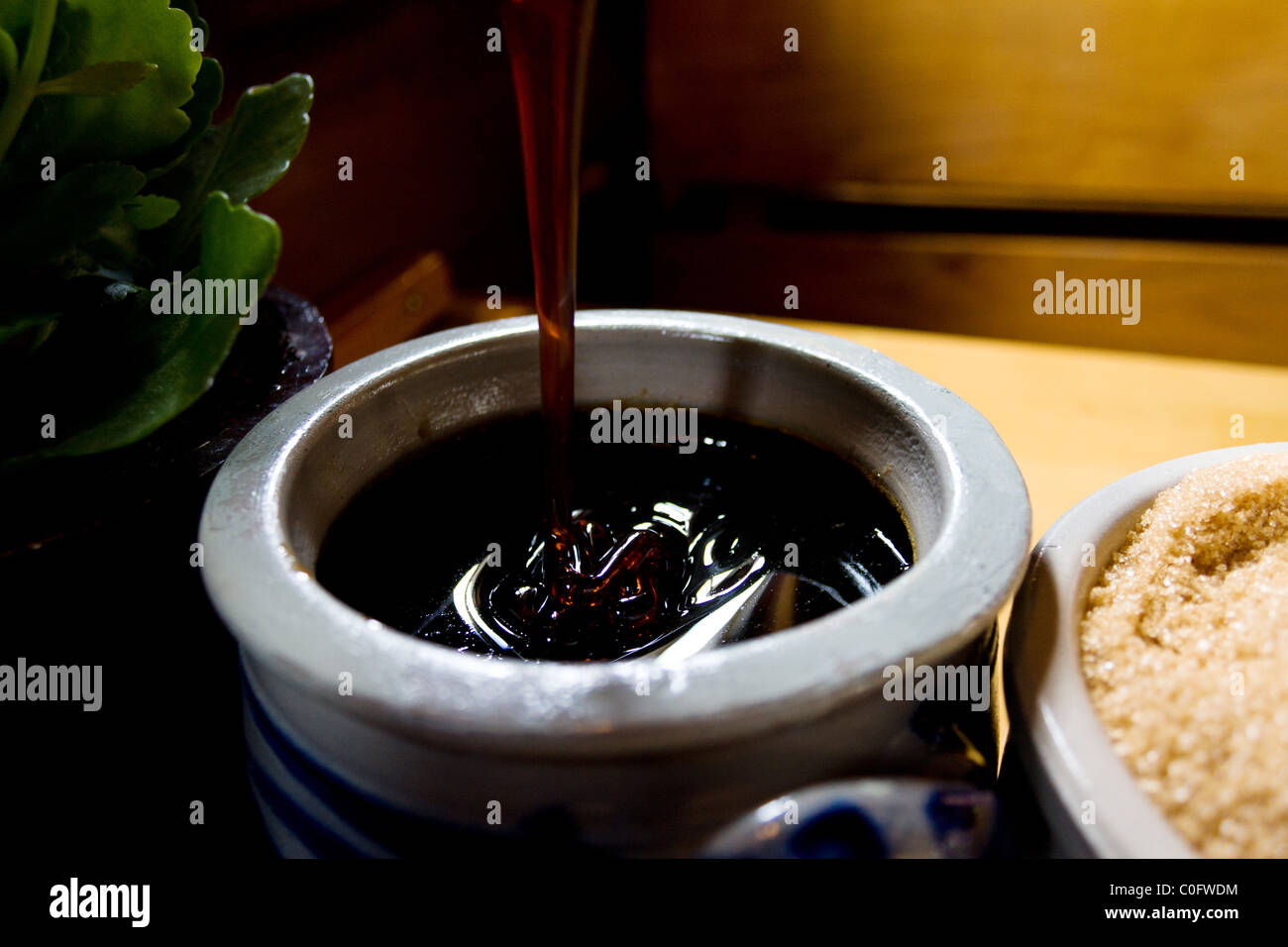 Thick syrup being poured into a jar at a pancake restaurant in ...