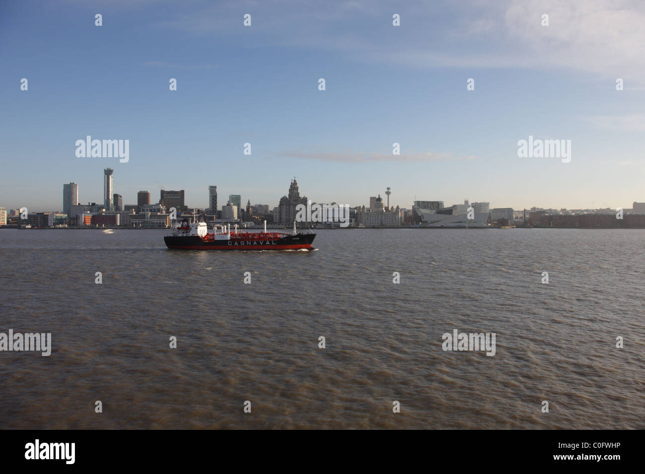 Casnaval vessel on the River Mersey. The Liverpool coastline from ...