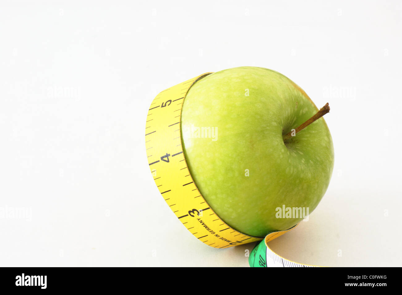 Measuring the apple Stock Photo - Alamy