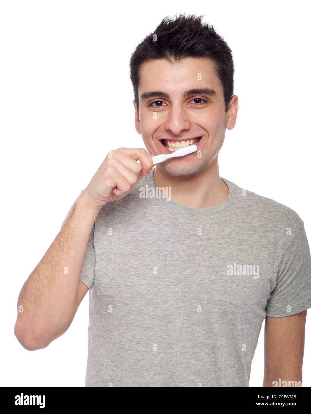 handsome young man brushing his teeth with toothbrush (isolated on ...