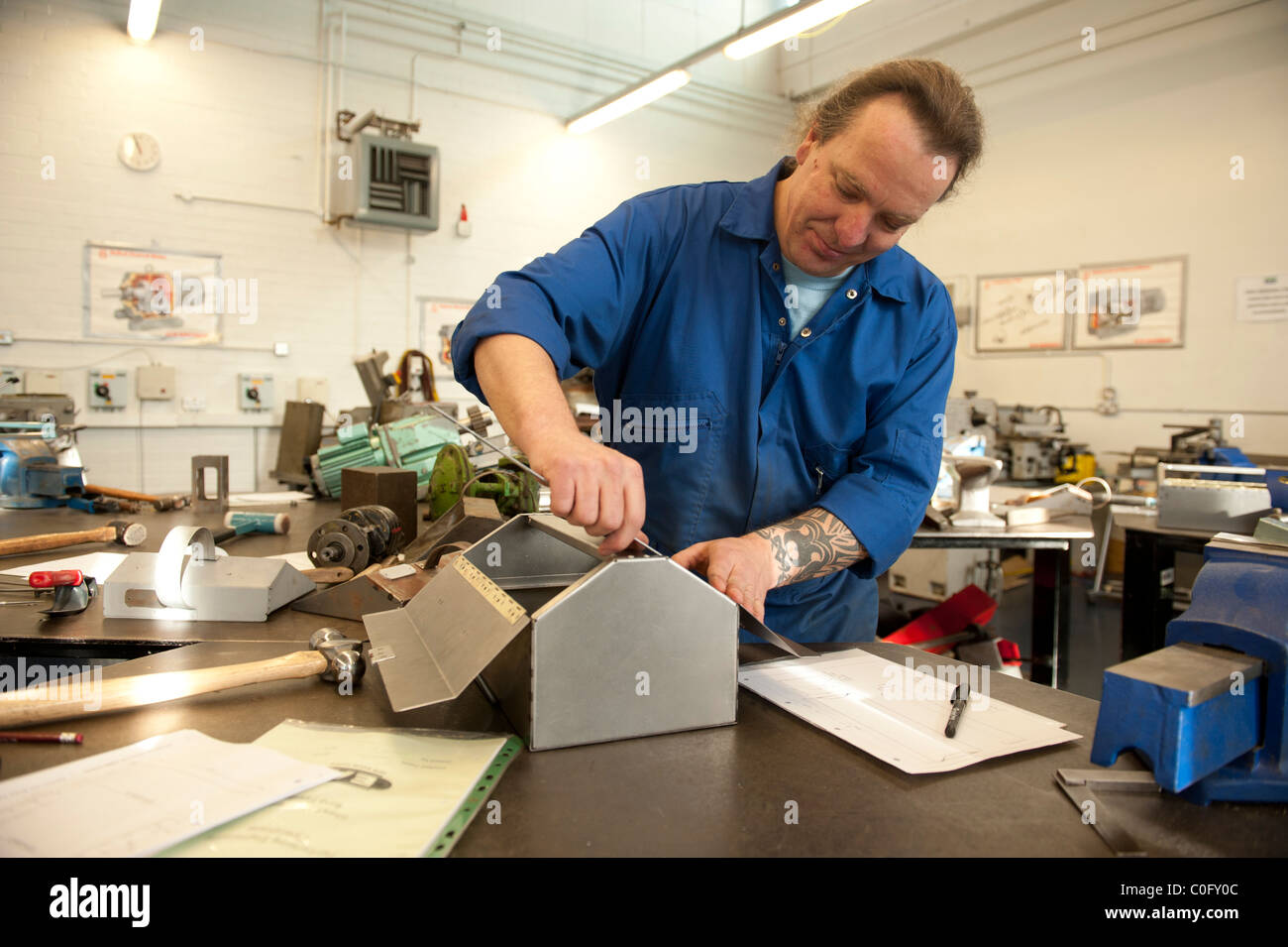 Adults learning metal working skills at a college of further education ...