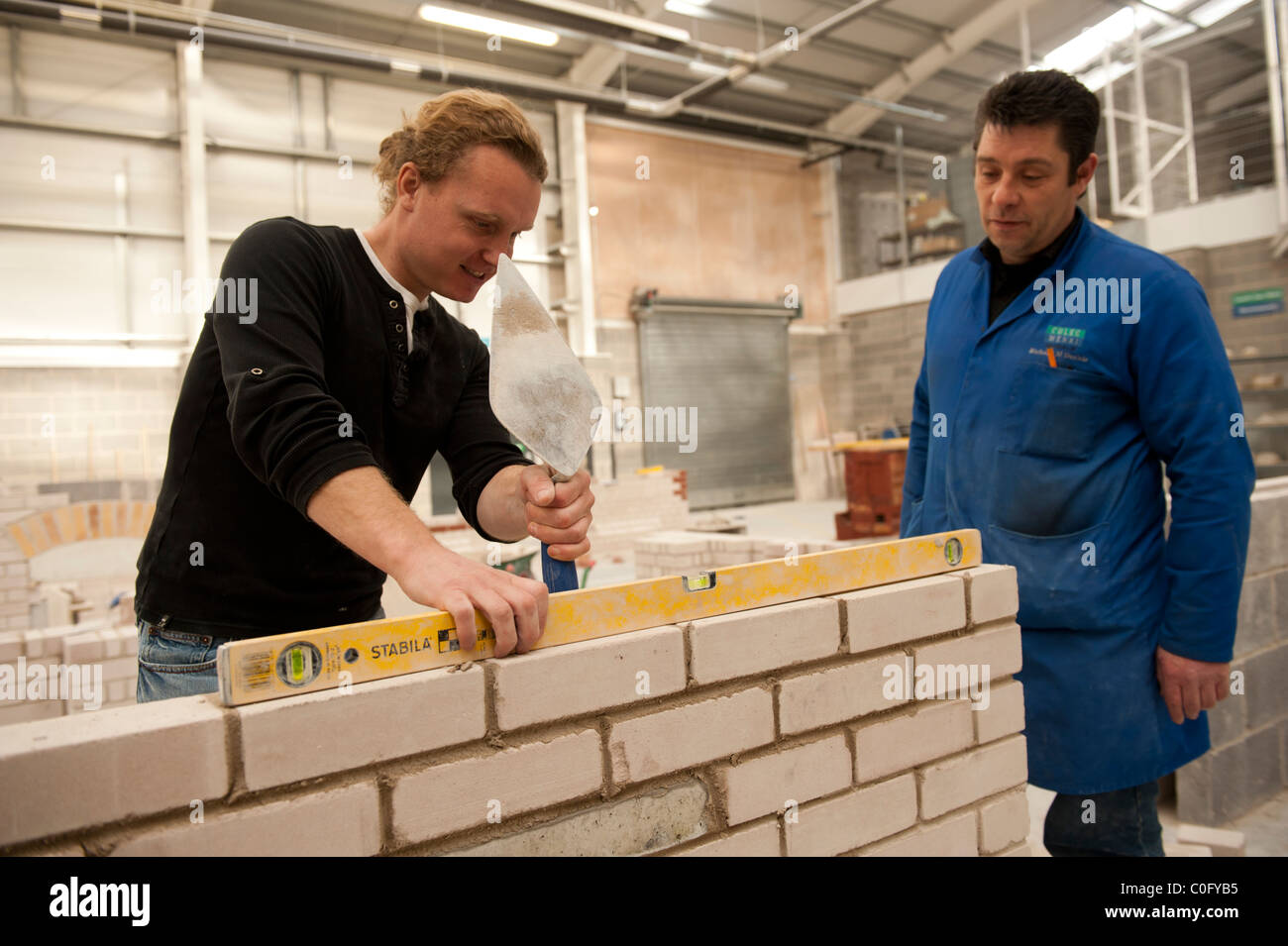 Bricklayer laying course bricks hi-res stock photography and images - Alamy