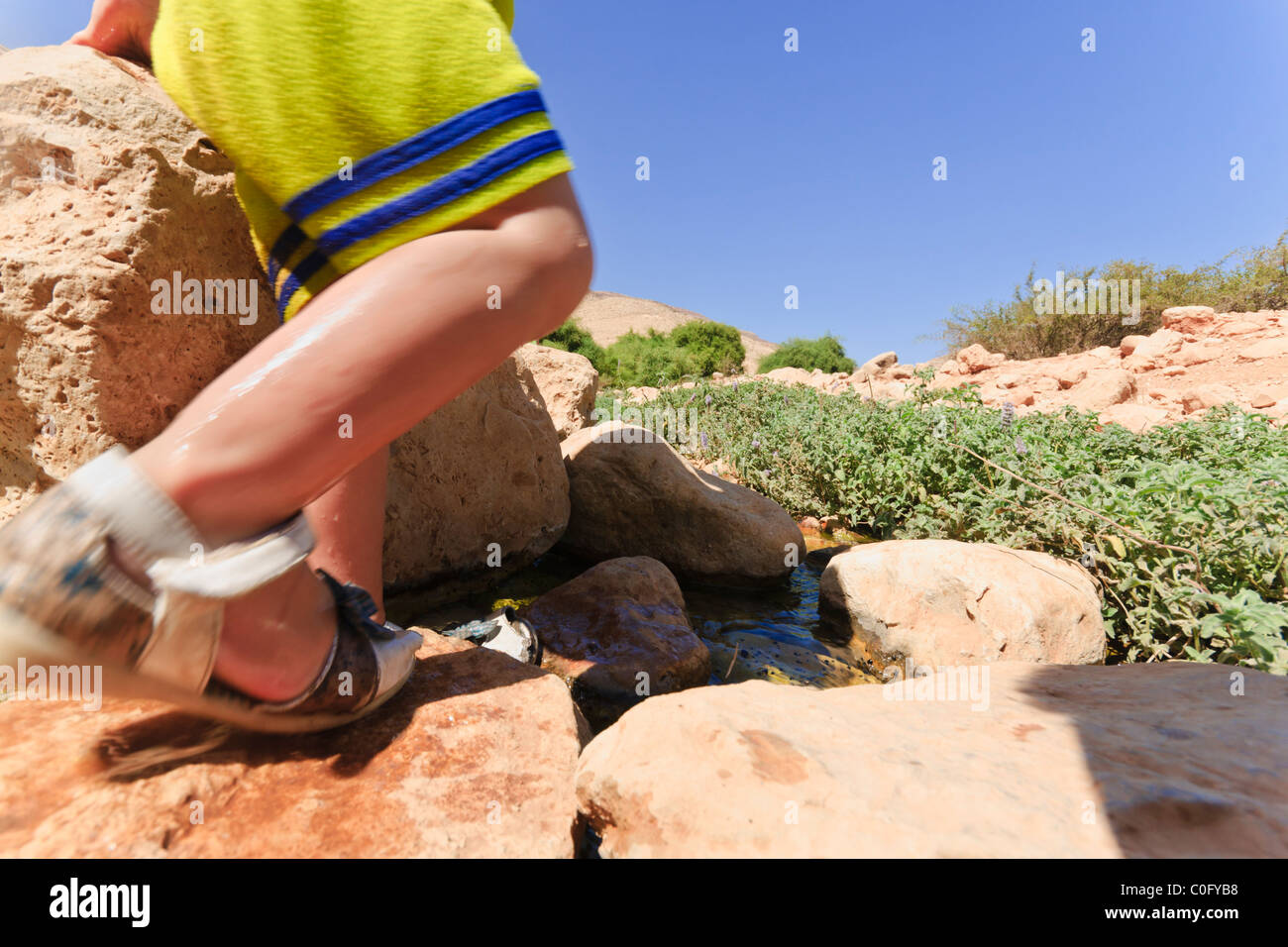 A Child walks at Patzaael Spring, Israel. an oasis in the Judea desert ...