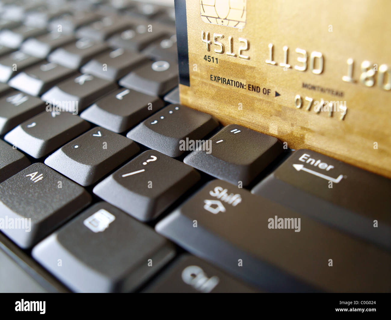 Golden credit card on computer keyboard Stock Photo - Alamy