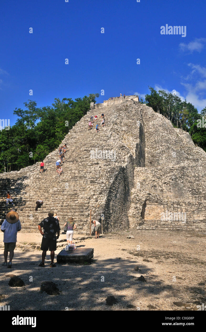 Tourists climbing the Nohoch Mul pyramid at the Mayan ruins of Coba ...