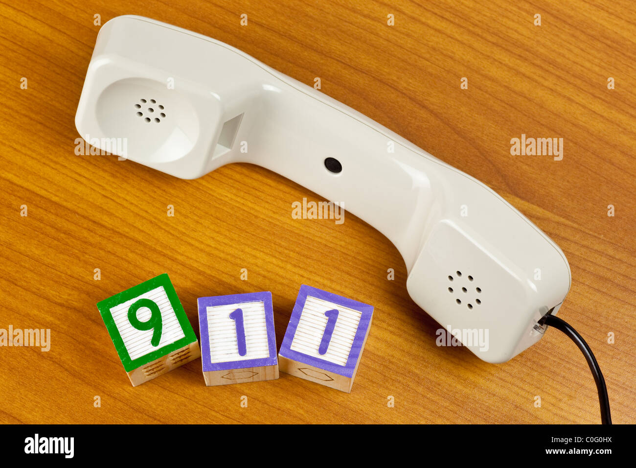 Phone handset with number blocks 911 on a table Stock Photo - Alamy