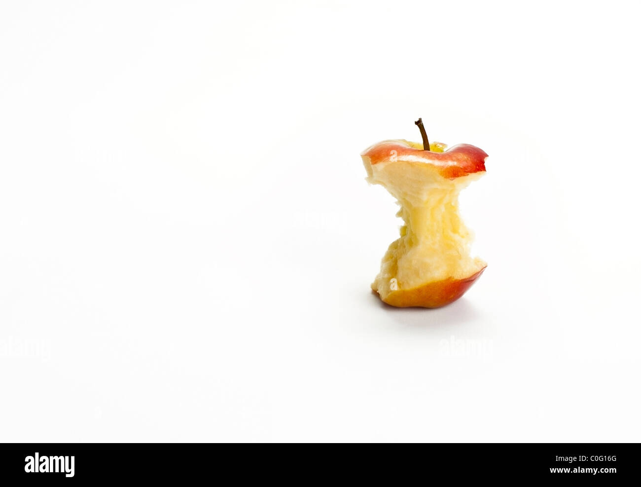 An apple core composed off center with white background and room for ...