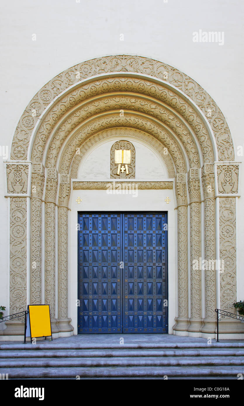Ornate Blue Church door with molded trim facade and yellow blank sign ...