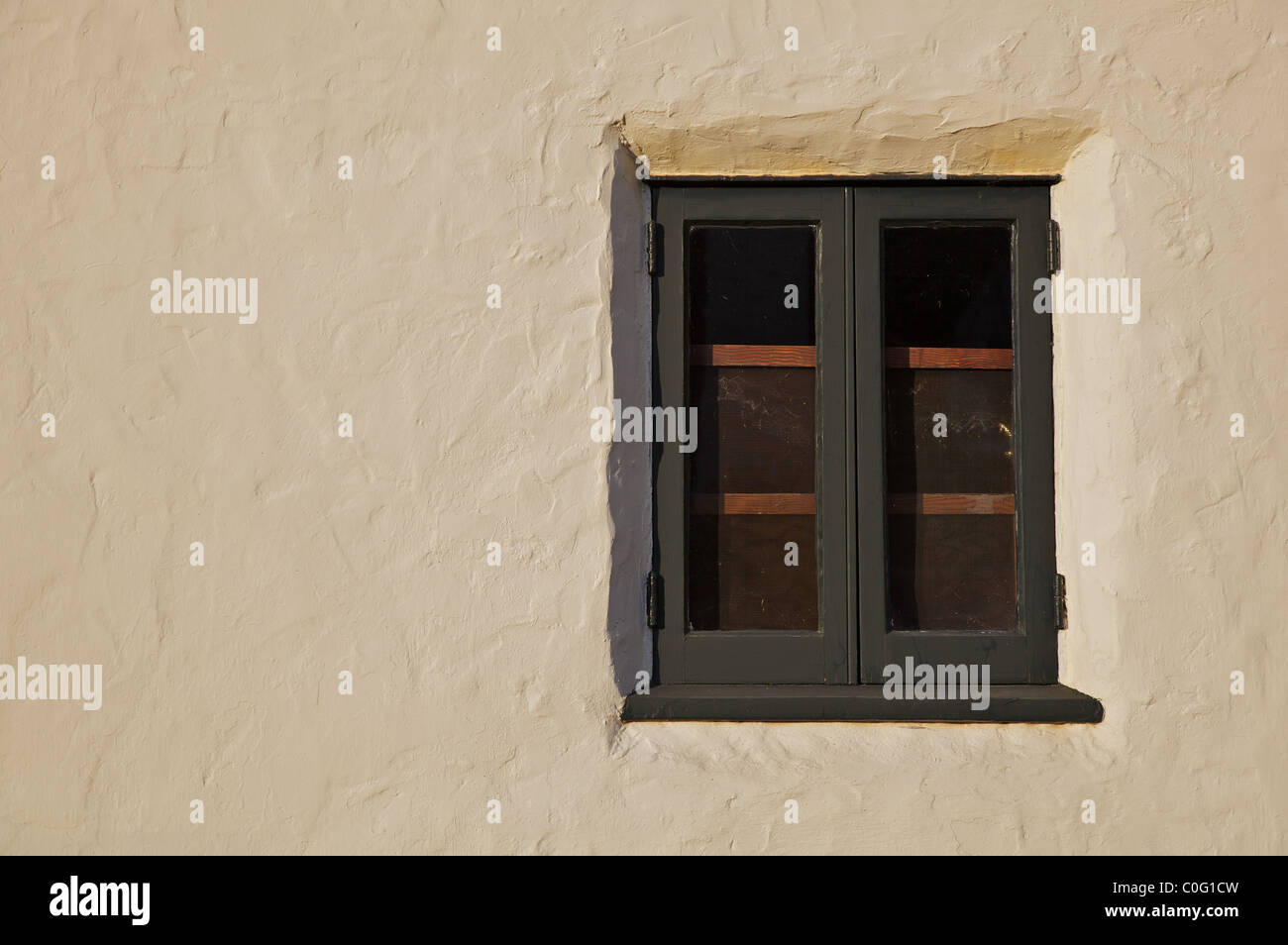 Old green wood window inset in a beige or tan stucco wall Stock Photo ...