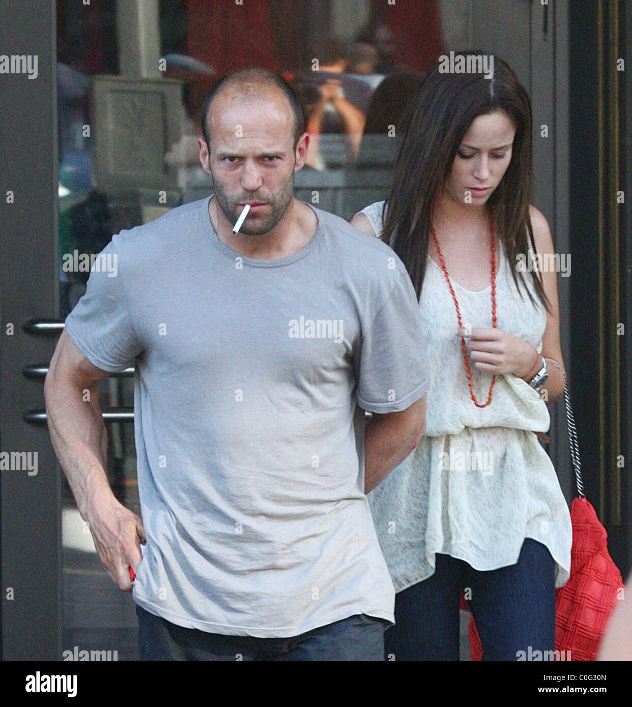 Jason Statham and his girlfriend leave a movie theatre after watching ...