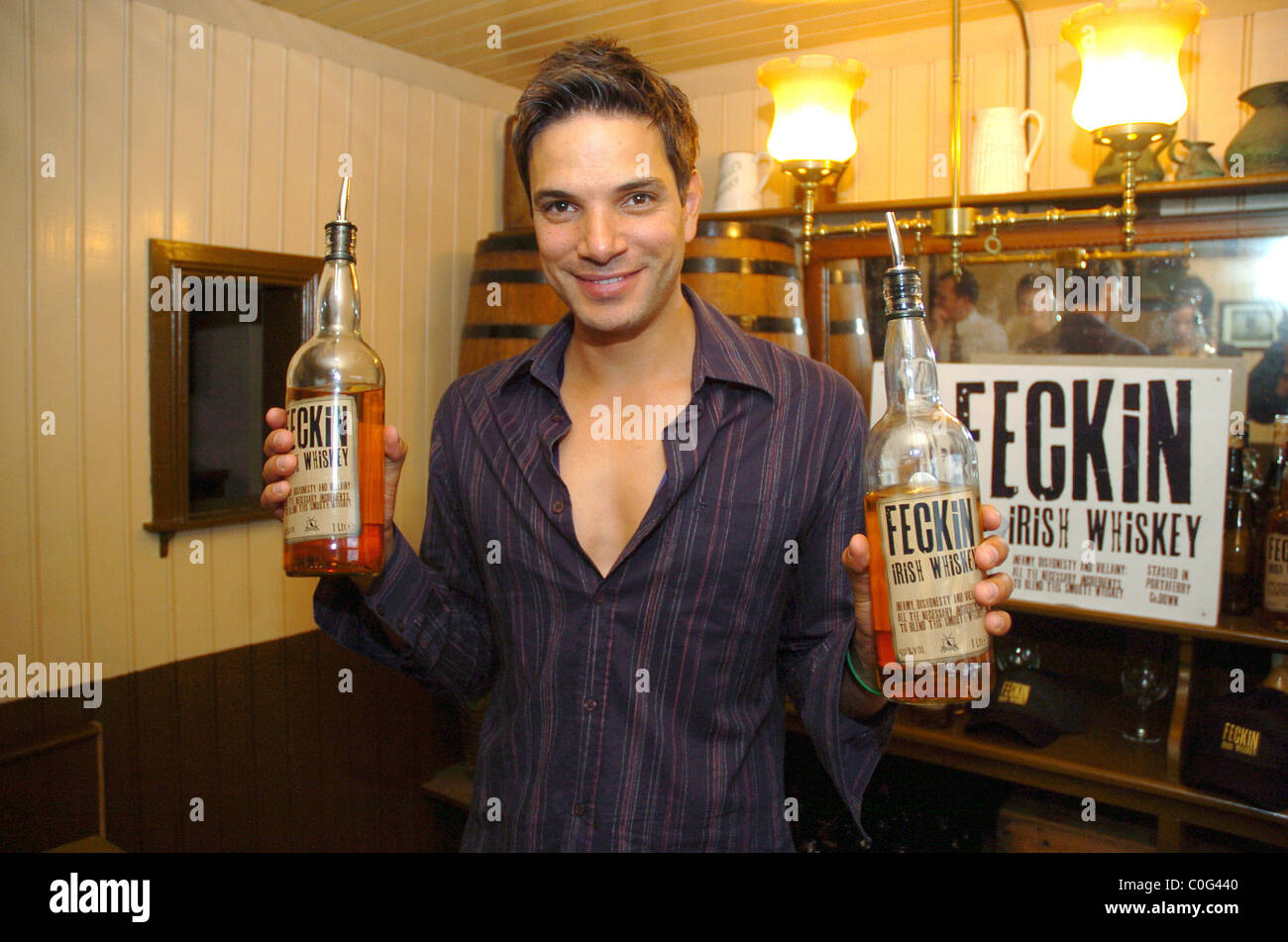 Matthew Bose holding a bottle of FECKIN whisky at the FECKIN Woolpack ...