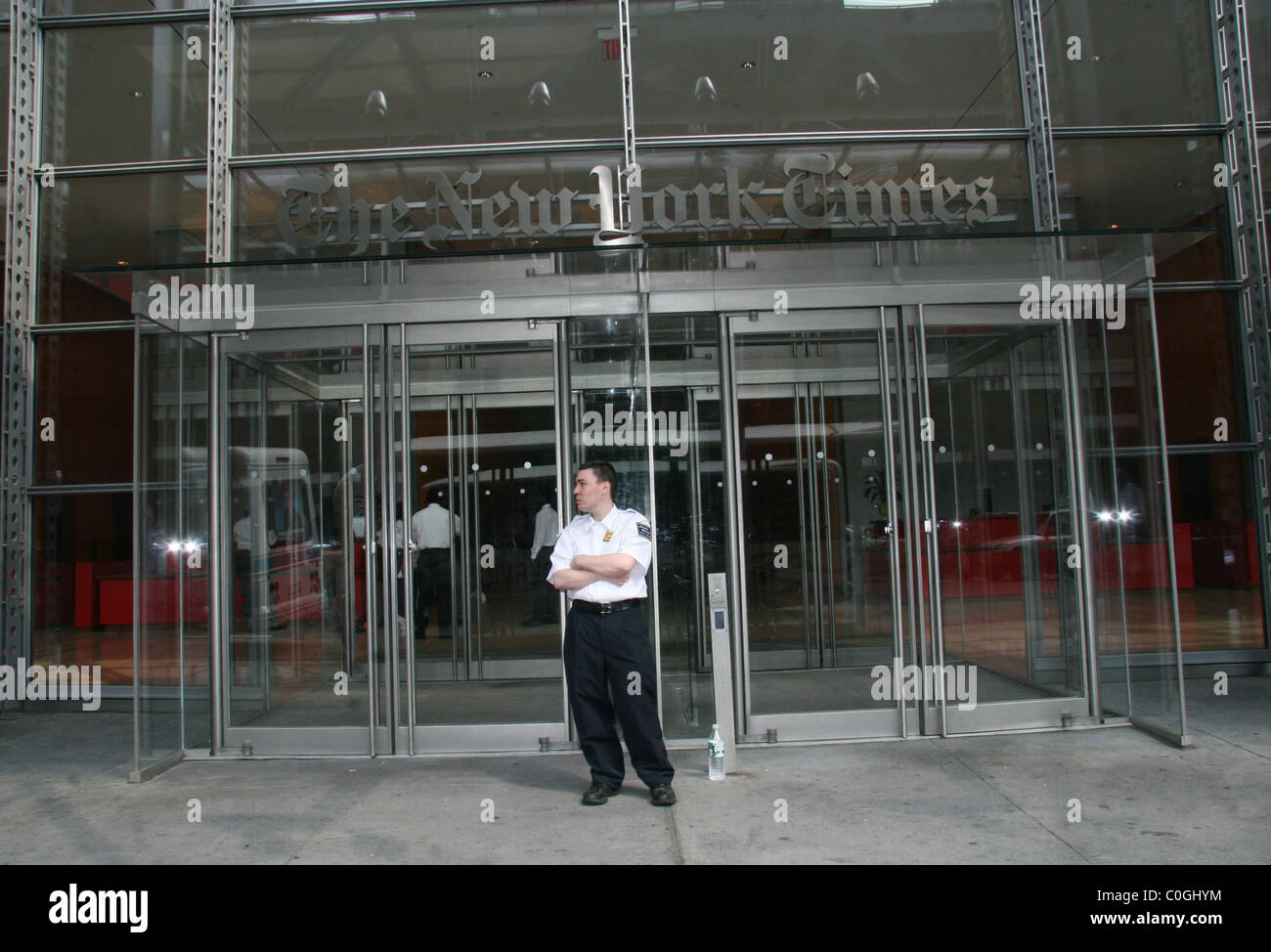 A security guard stands in front of the New York Times building to ...