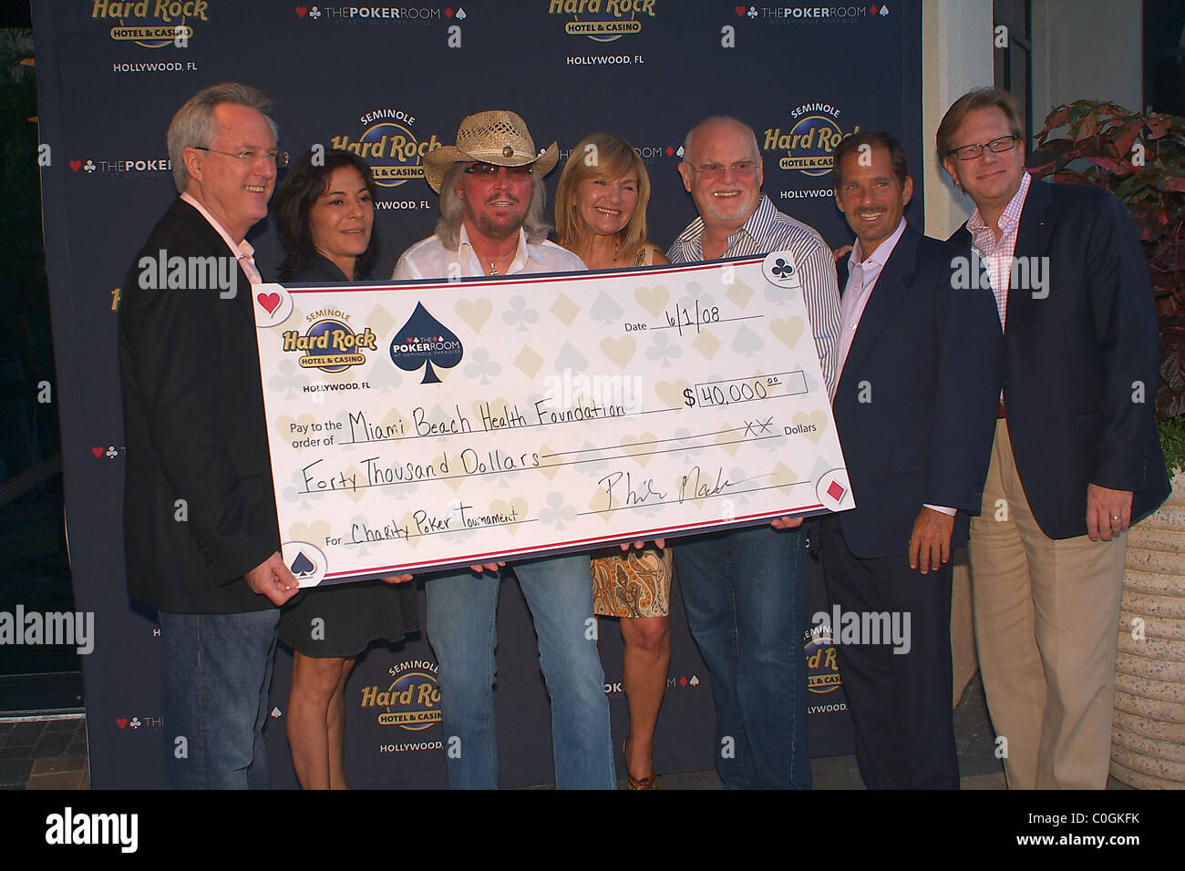 Barry Gibb is presented with a cheque from the Hard Rock Hotel and ...