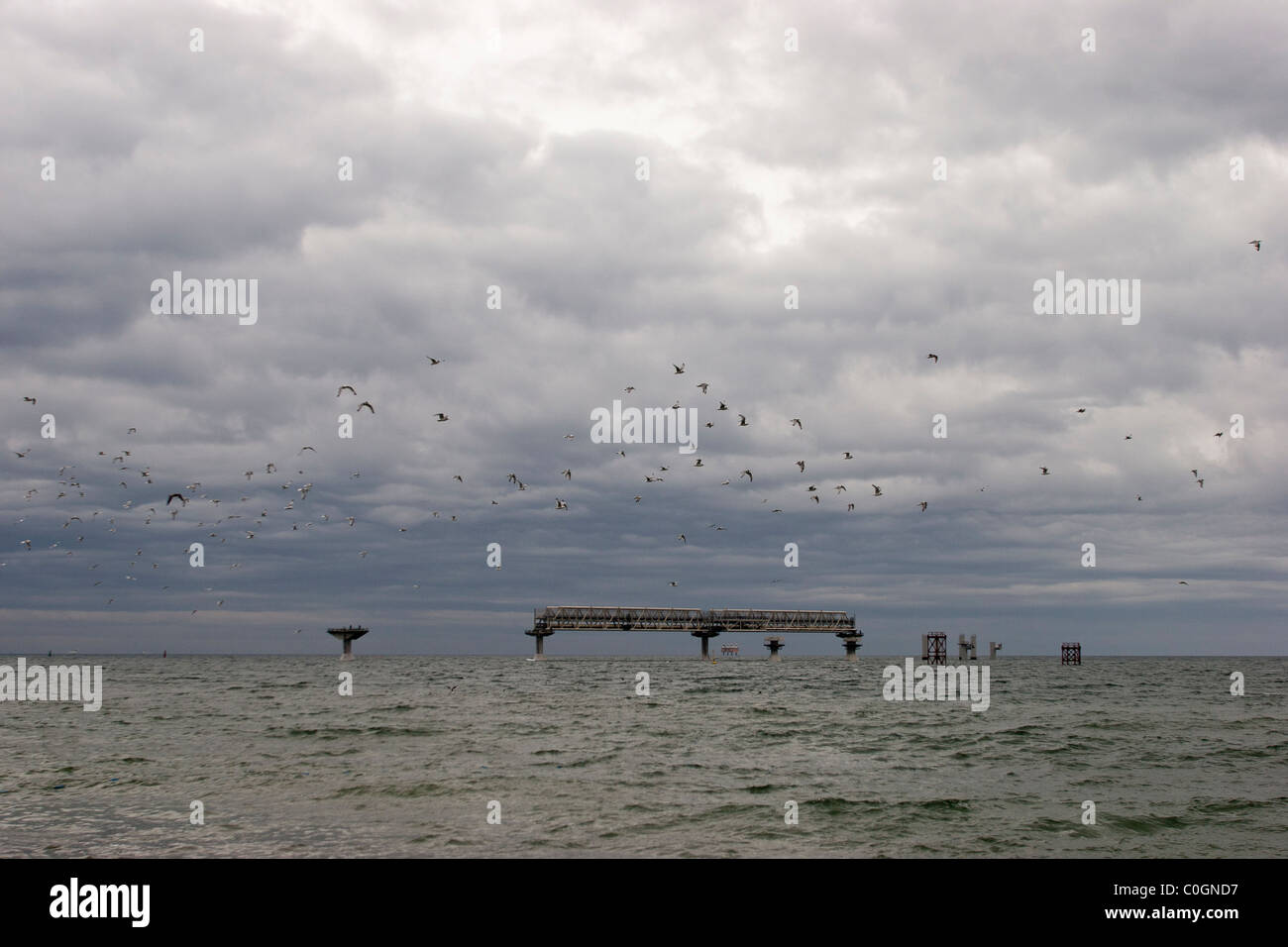 The gas loading jetty under construction offshore from the Sakenergy ...