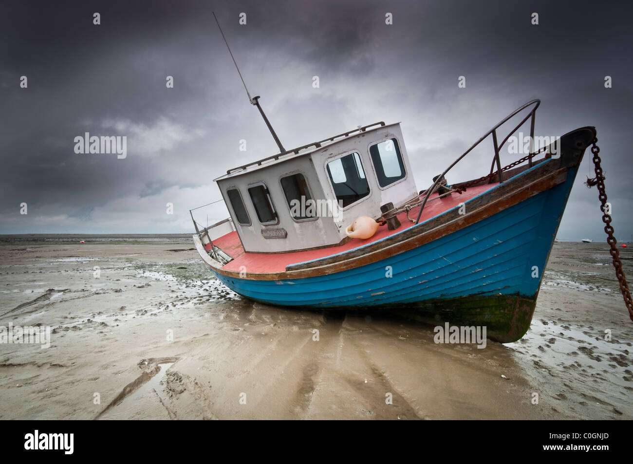 Derelict fishing boat stranded on sand, gloomy weather Stock Photo - Alamy