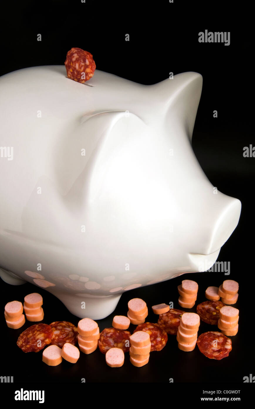 Piggy money box with salami and hotdogs coins Stock Photo - Alamy