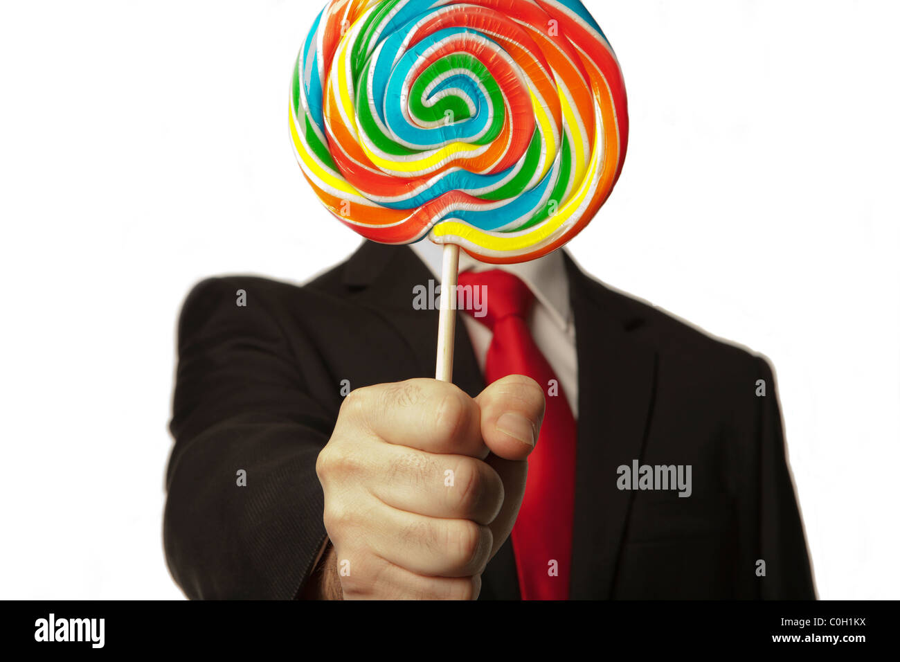businessman holding up lollipop to his face Stock Photo - Alamy