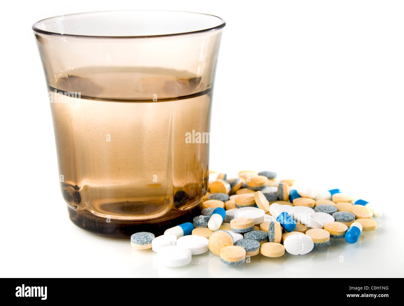 Medical tablets and glass of water Stock Photo - Alamy
