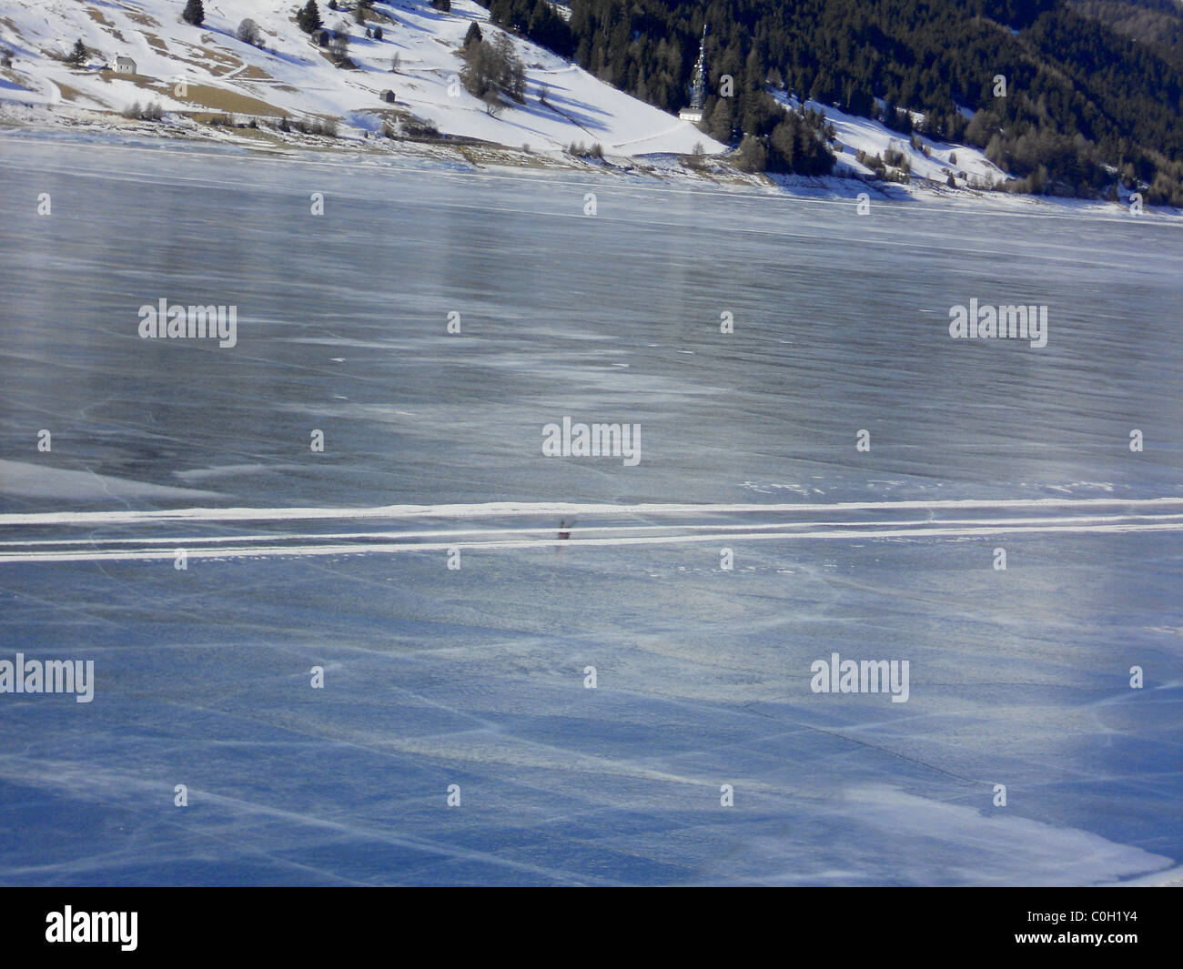 Reschensee frozen in winter with a bell tower in the lake Stock Photo ...
