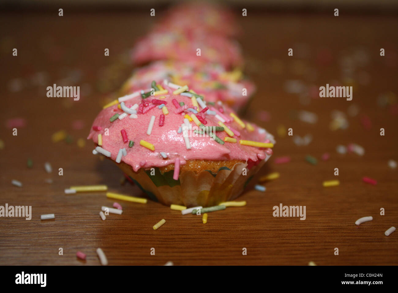 Cute cupcakes in a line Stock Photo - Alamy