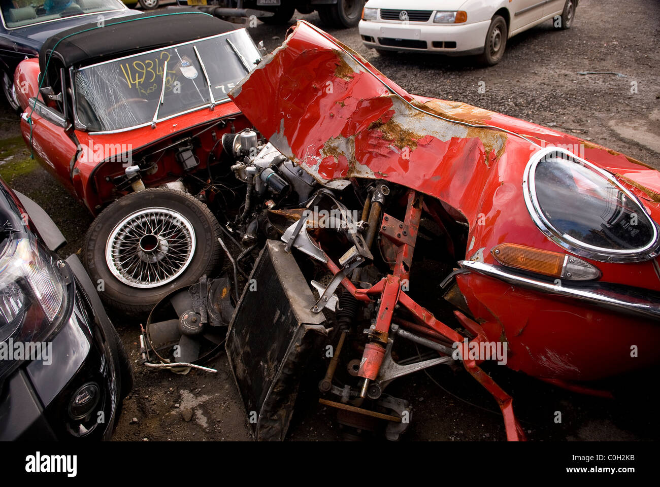 Crashed E-type Jaguar in a recovery yard in West Sussex, UK Stock Photo ... Crashed E-type Jaguar in a recovery yard in West Sussex, UK Stock Photo ...