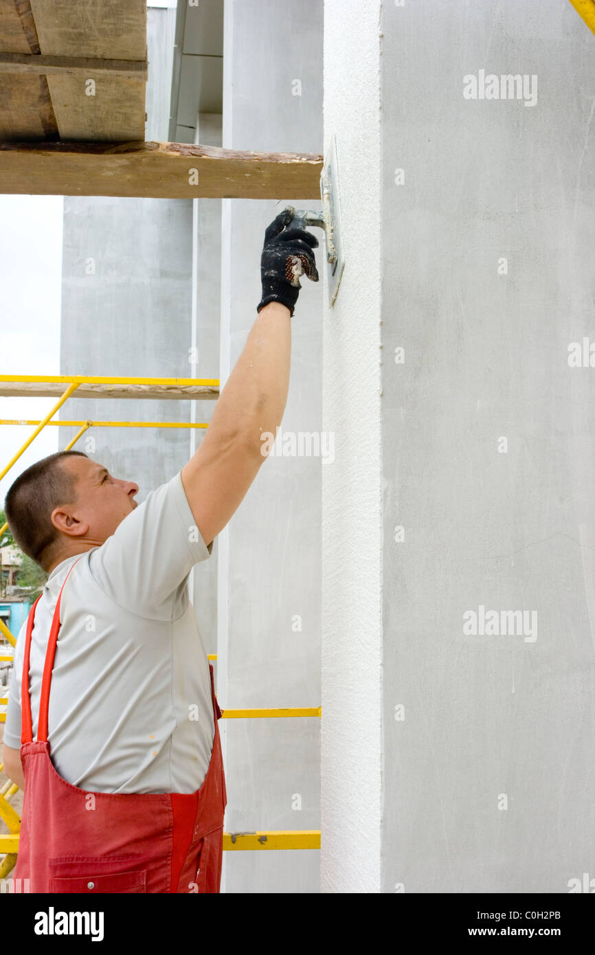 Smoothing of impressive plaster on a wall. A finishing stage Stock ...