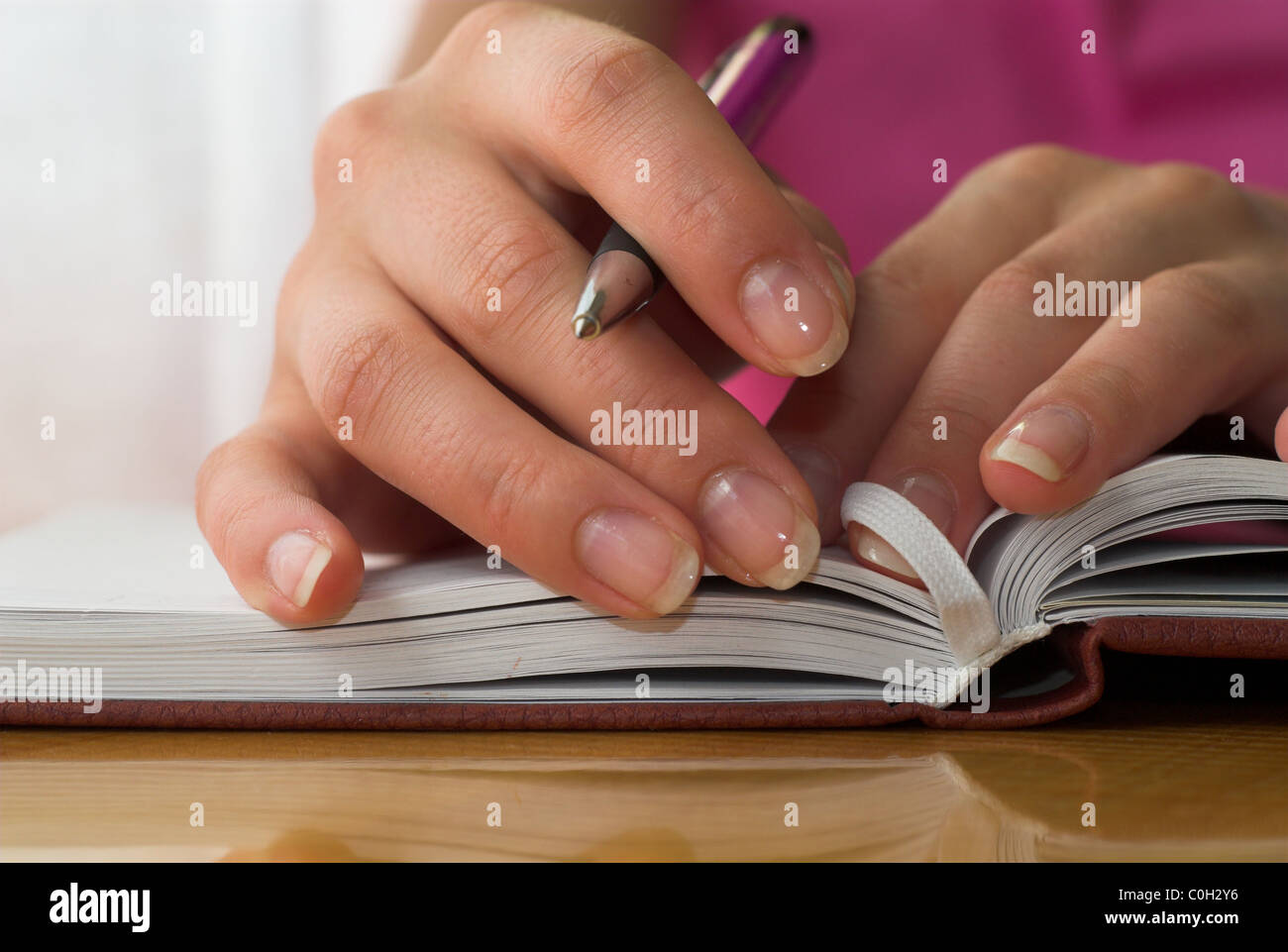 Nice hands with french manicure on the notebook Stock Photo - Alamy