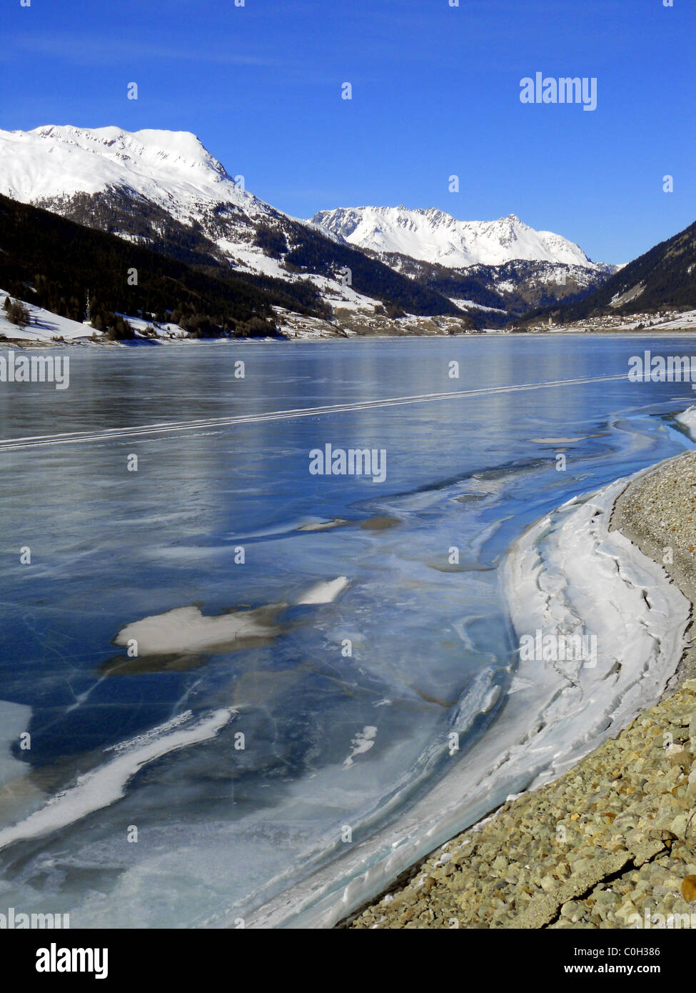 Reschensee frozen in winter with a bell tower in the lake Stock Photo ...