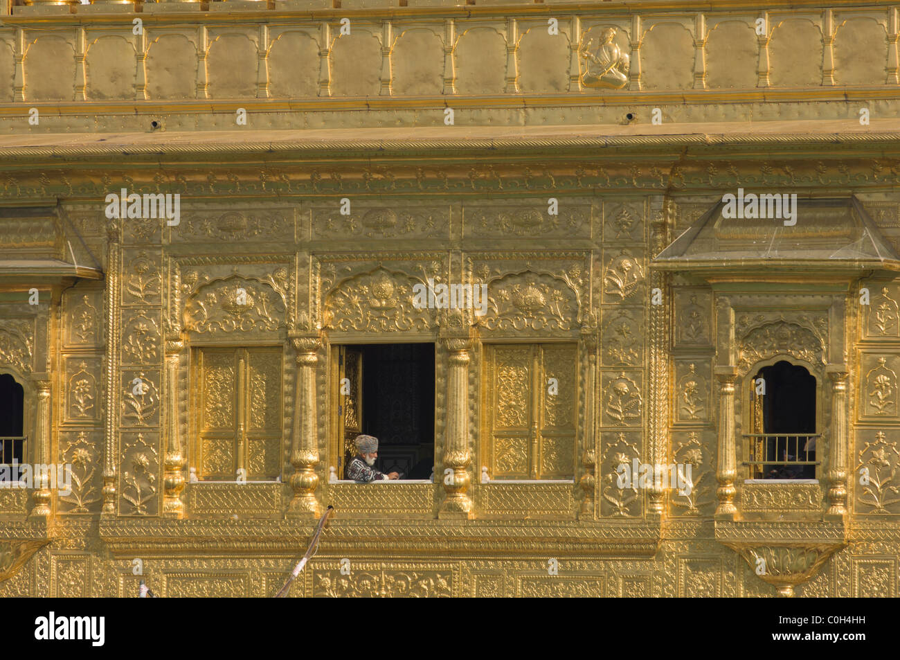 Pilgrim reading in a window of the Hari Mandir (Divine Temple), Golden ...