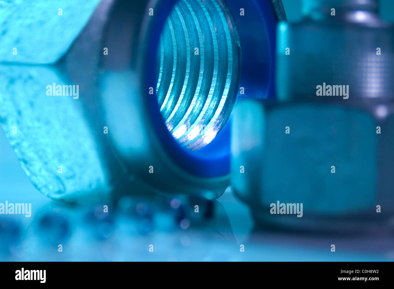 nuts and screw in blue Stock Photo - Alamy