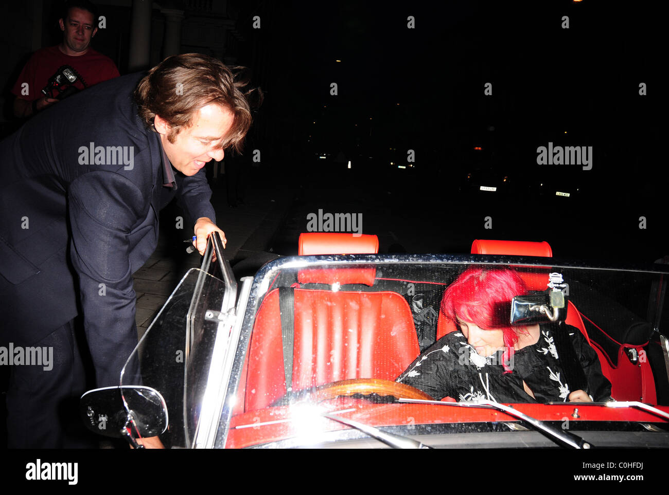 Jonathan Ross climbs into and squeezes into the driving seat of his ...