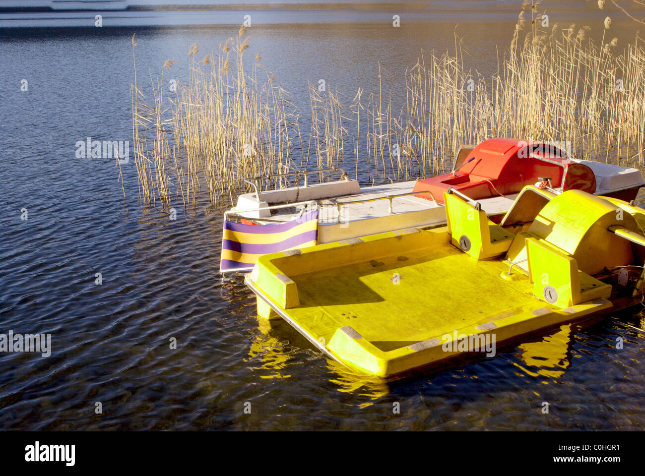mirror lake with small boat rowing Stock Photo - Alamy