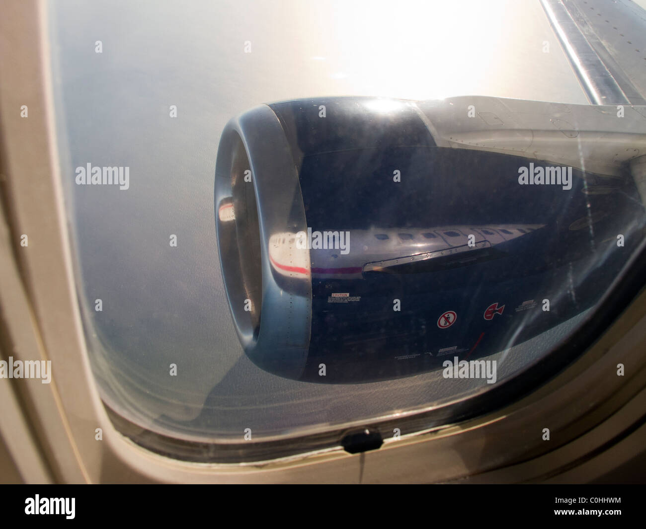 Jet engine seen through cabin window Stock Photo - Alamy