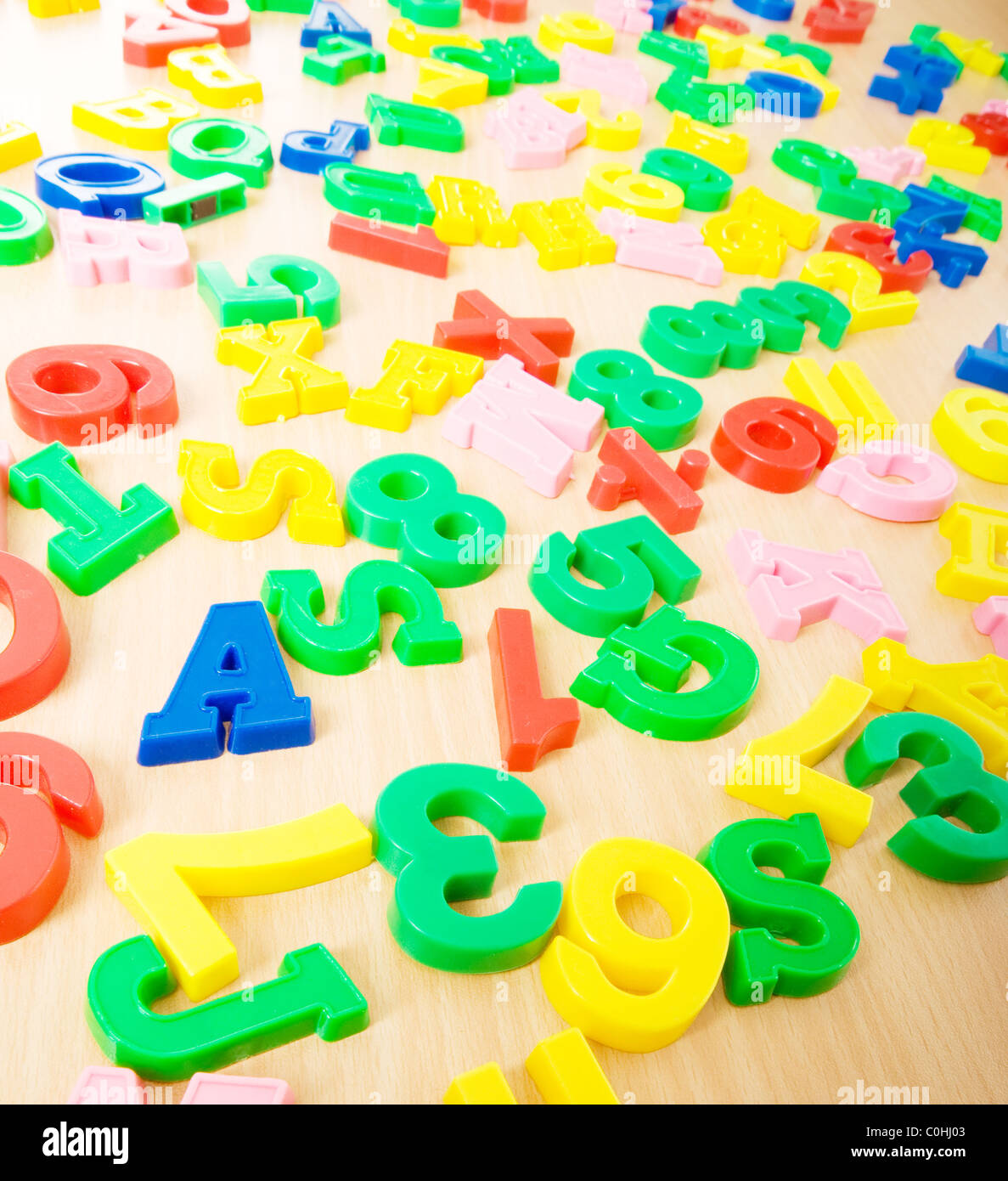 Children letters and digits on the table Stock Photo - Alamy