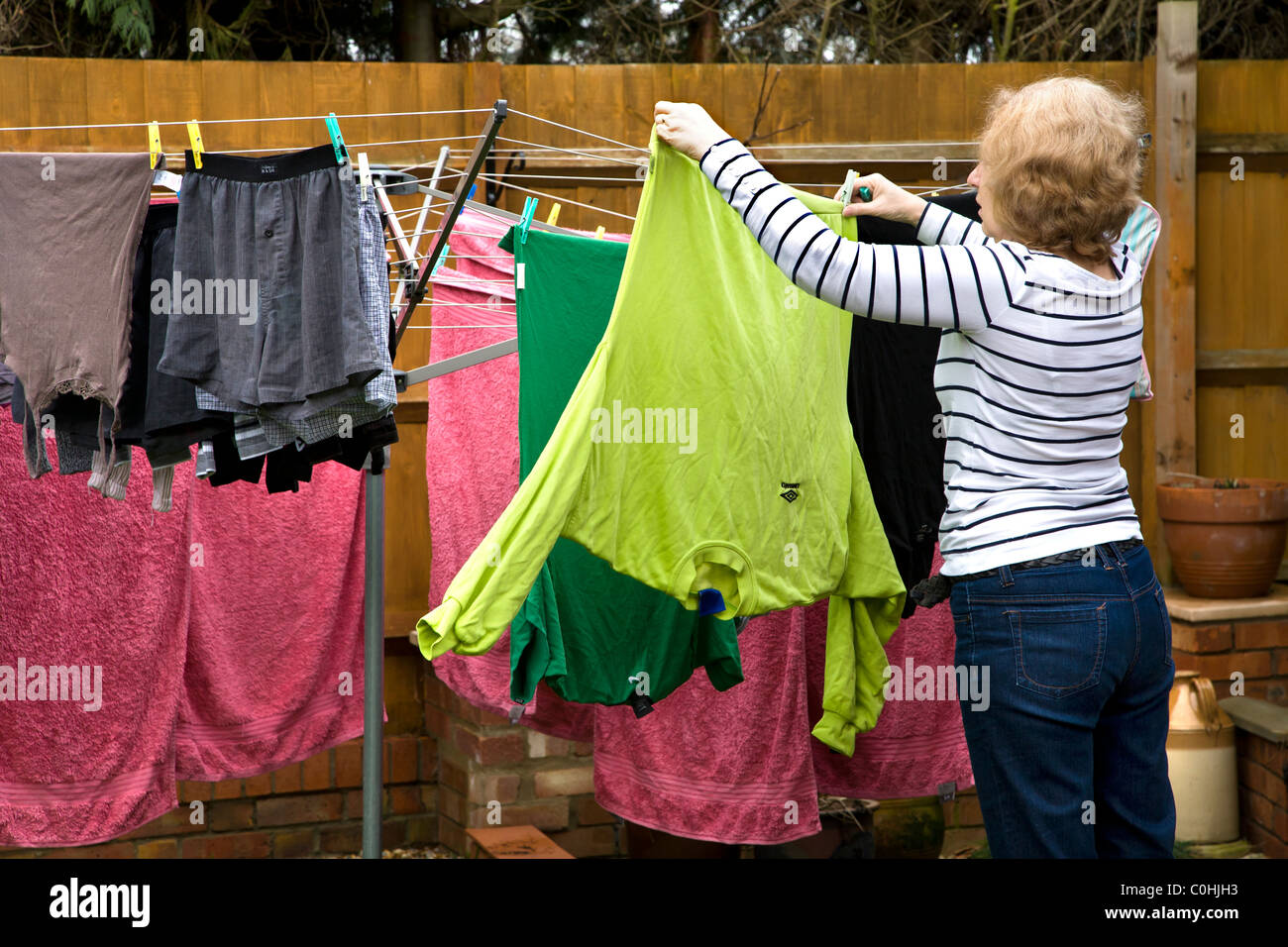 hanging washing on a rotary line Stock Photo - Alamy