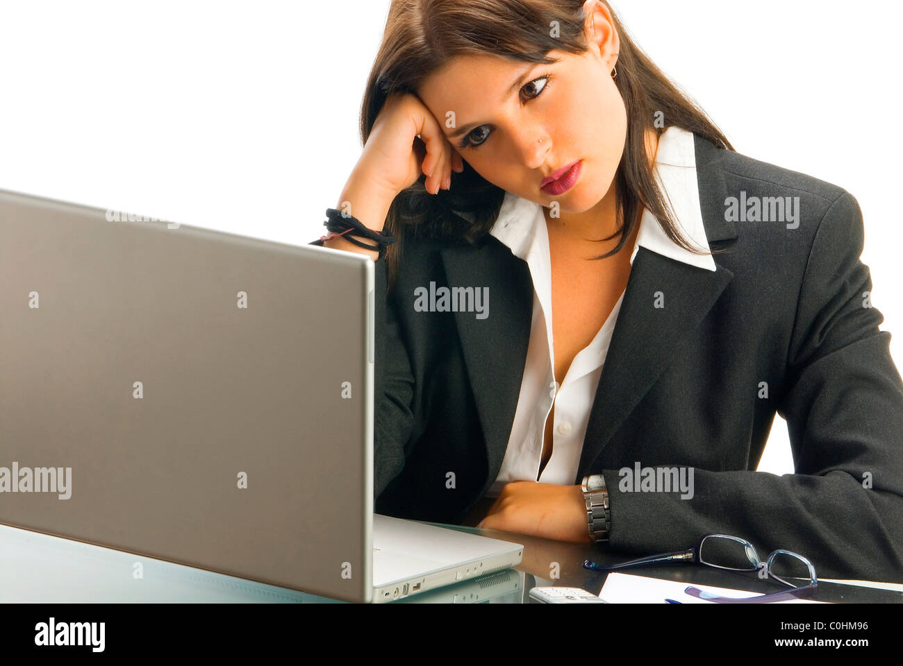 a white collar worker in formal black tailleur sitting at her desk ...