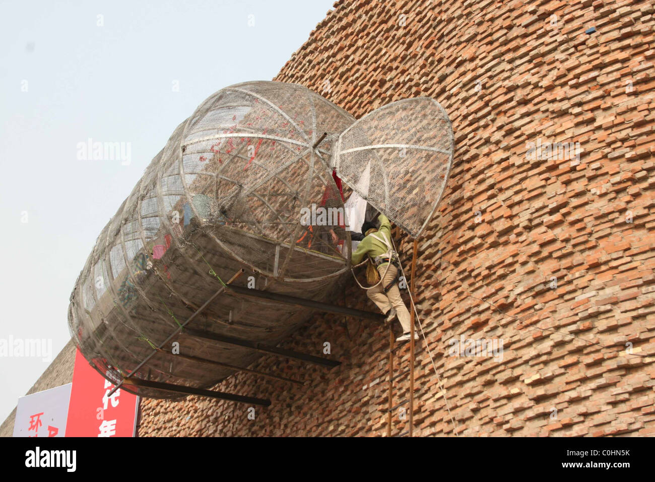 WOMAN MAKES POD HER NEW HOME A woman in China is living on the side of ...