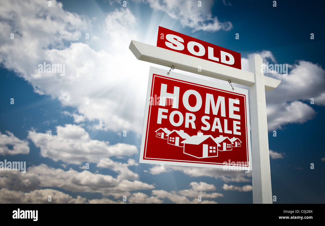 Red Sold Home For Sale Real Estate Sign Over Beautiful Clouds and Blue ...