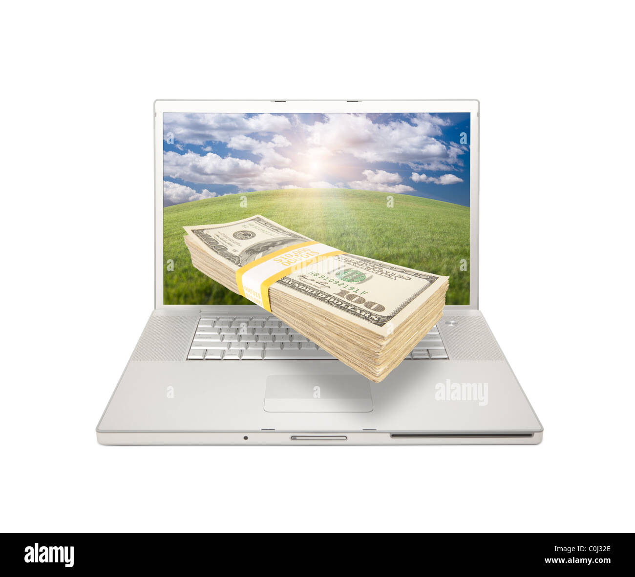 Silver Computer Laptop Isolated on White with Stacks of Hundred Dollar ...
