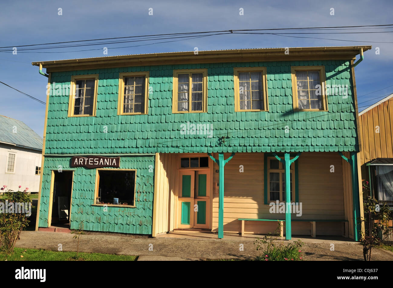 Two-storey, green painted wooden shingles tejuelas building housing an ...