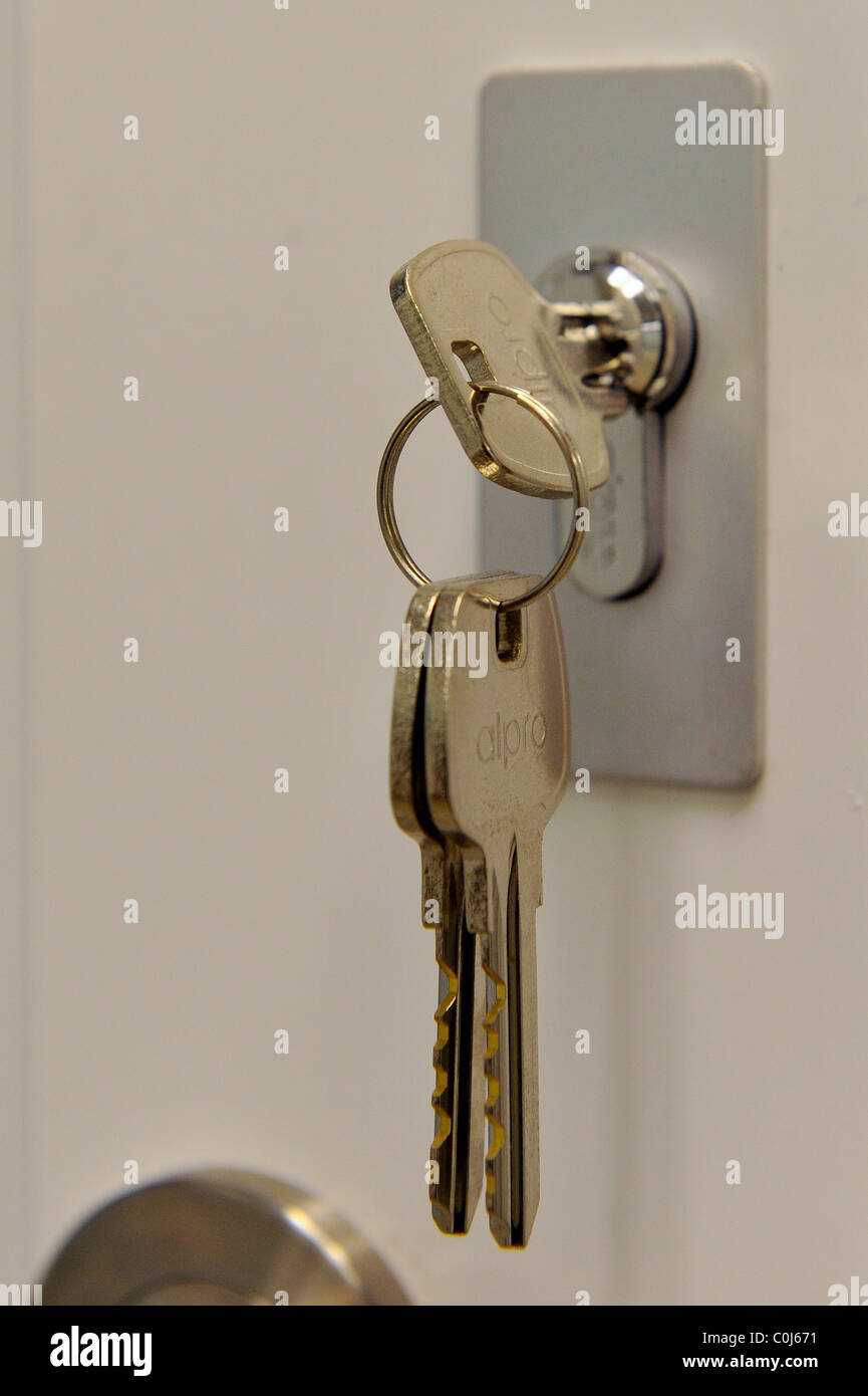 Keys in a lock Stock Photo - Alamy