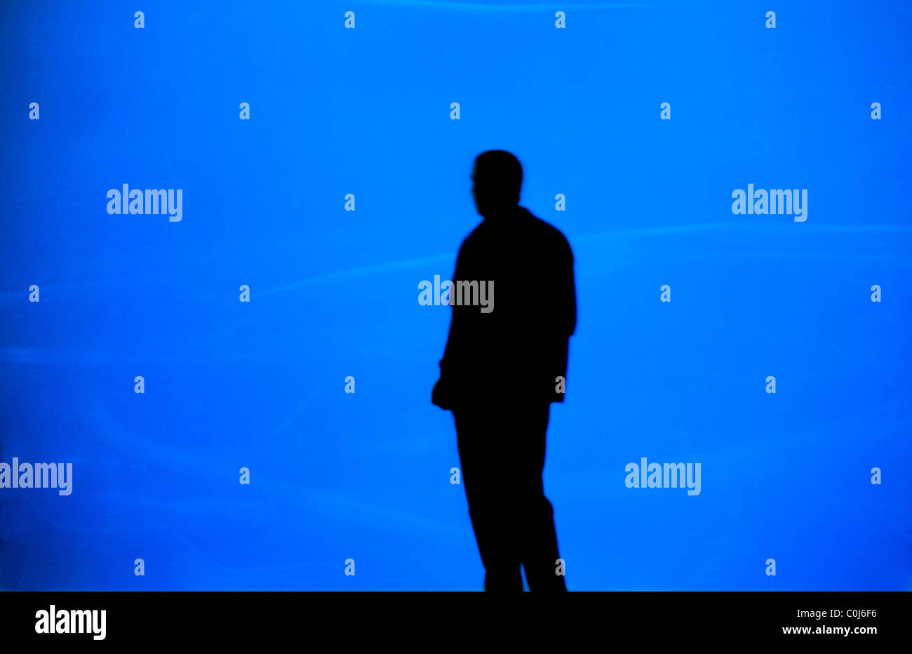 silhouettes of people against a mysterious blue background Stock Photo ...