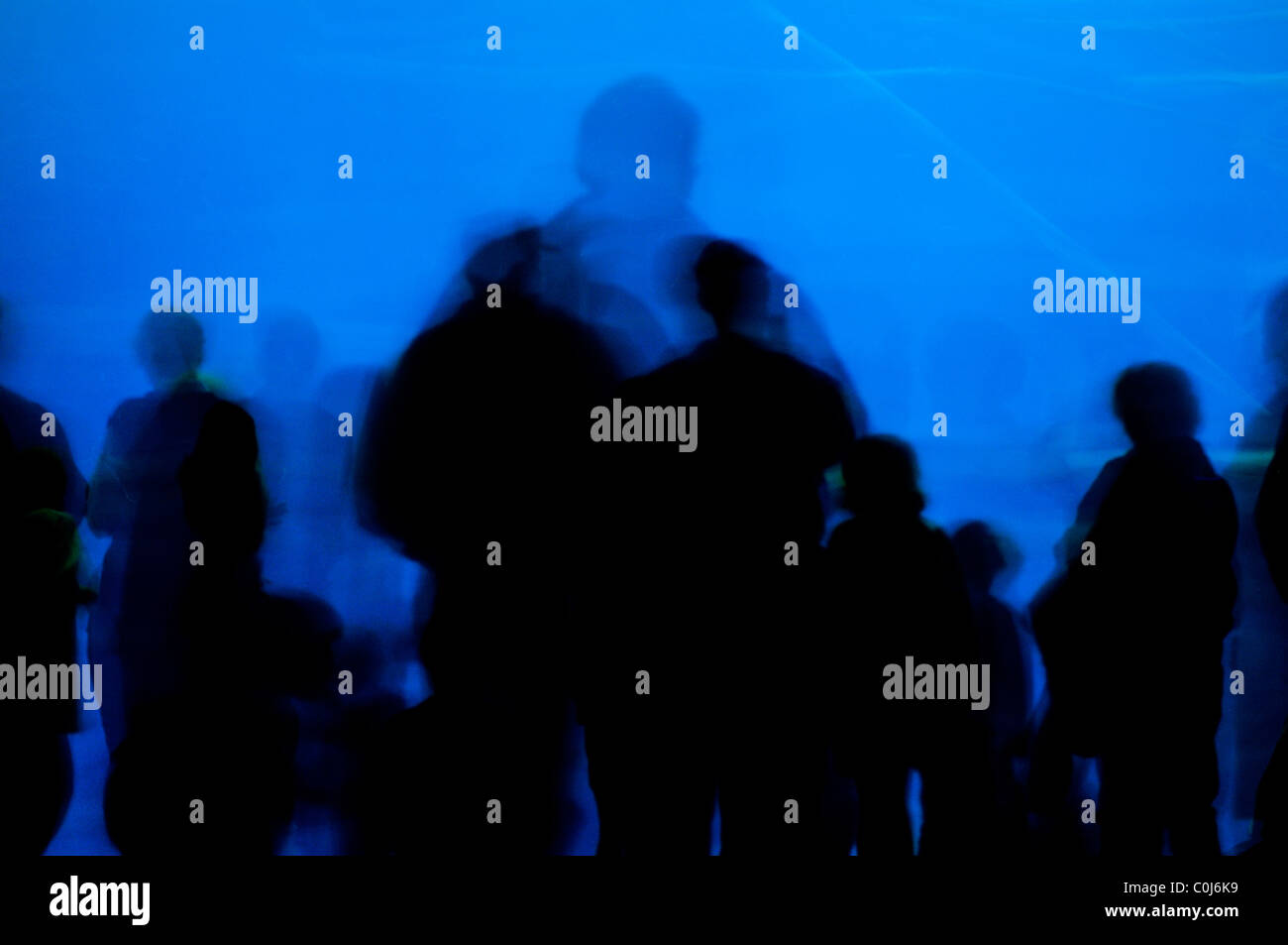 silhouettes of people against a mysterious blue background Stock Photo ...