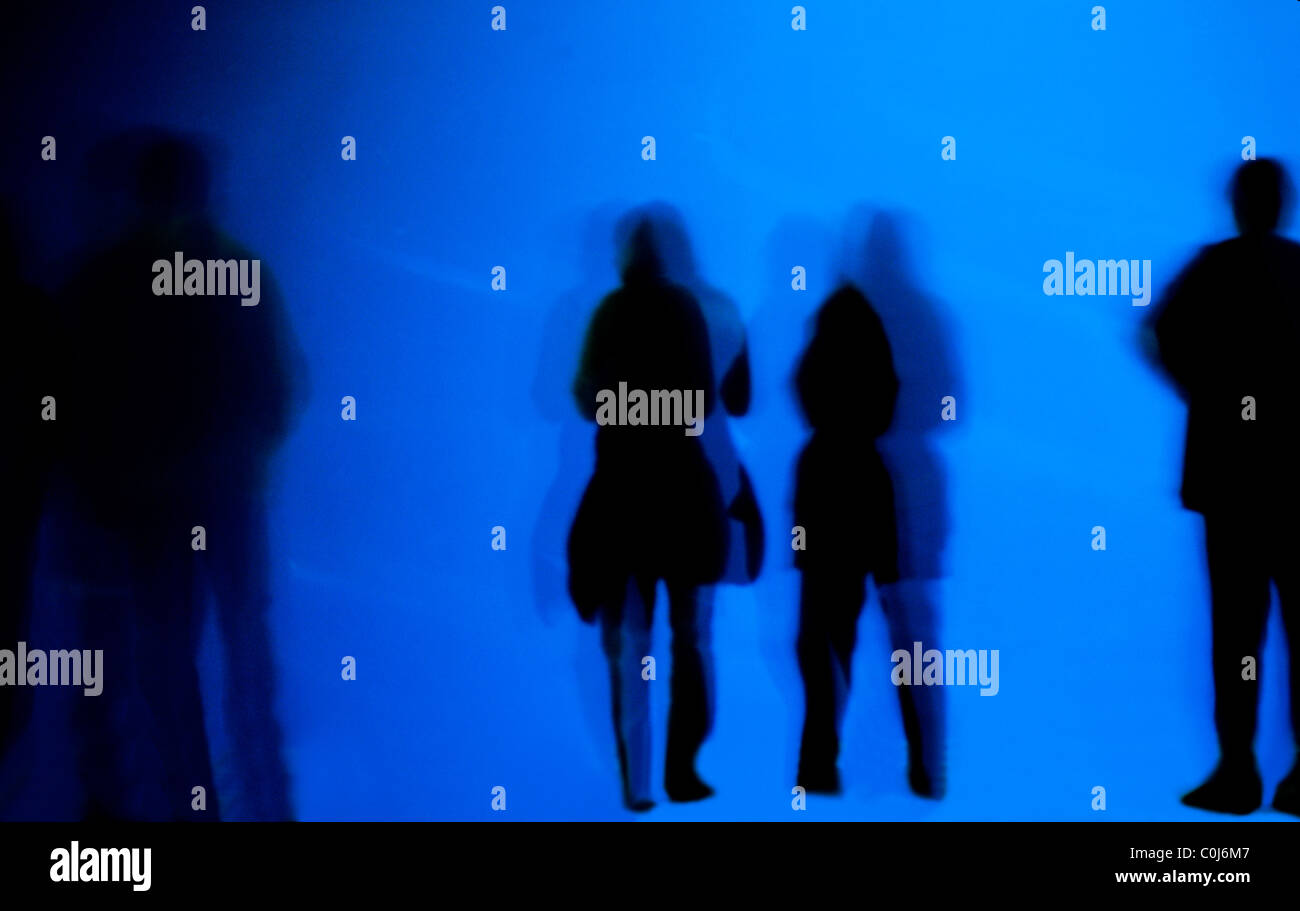silhouettes of people against a mysterious blue background Stock Photo ...
