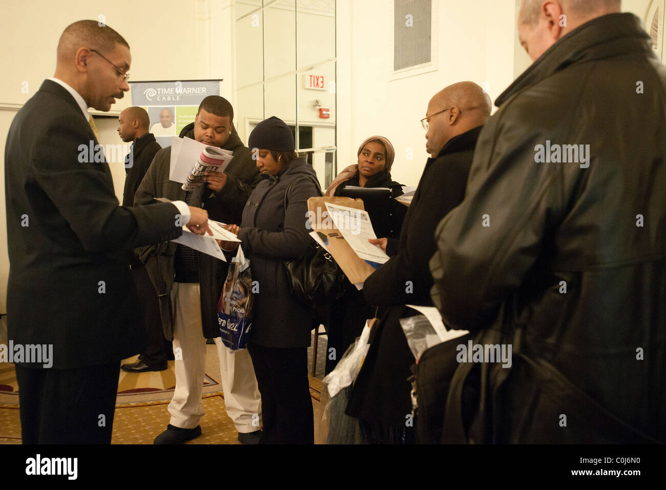 Job seekers listen to a job recruiter at a job fair in midtown in New ...