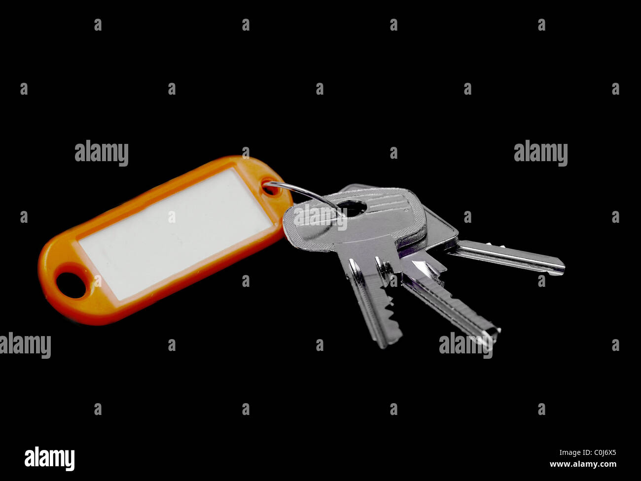 Keys isolated on black with empty label Stock Photo - Alamy