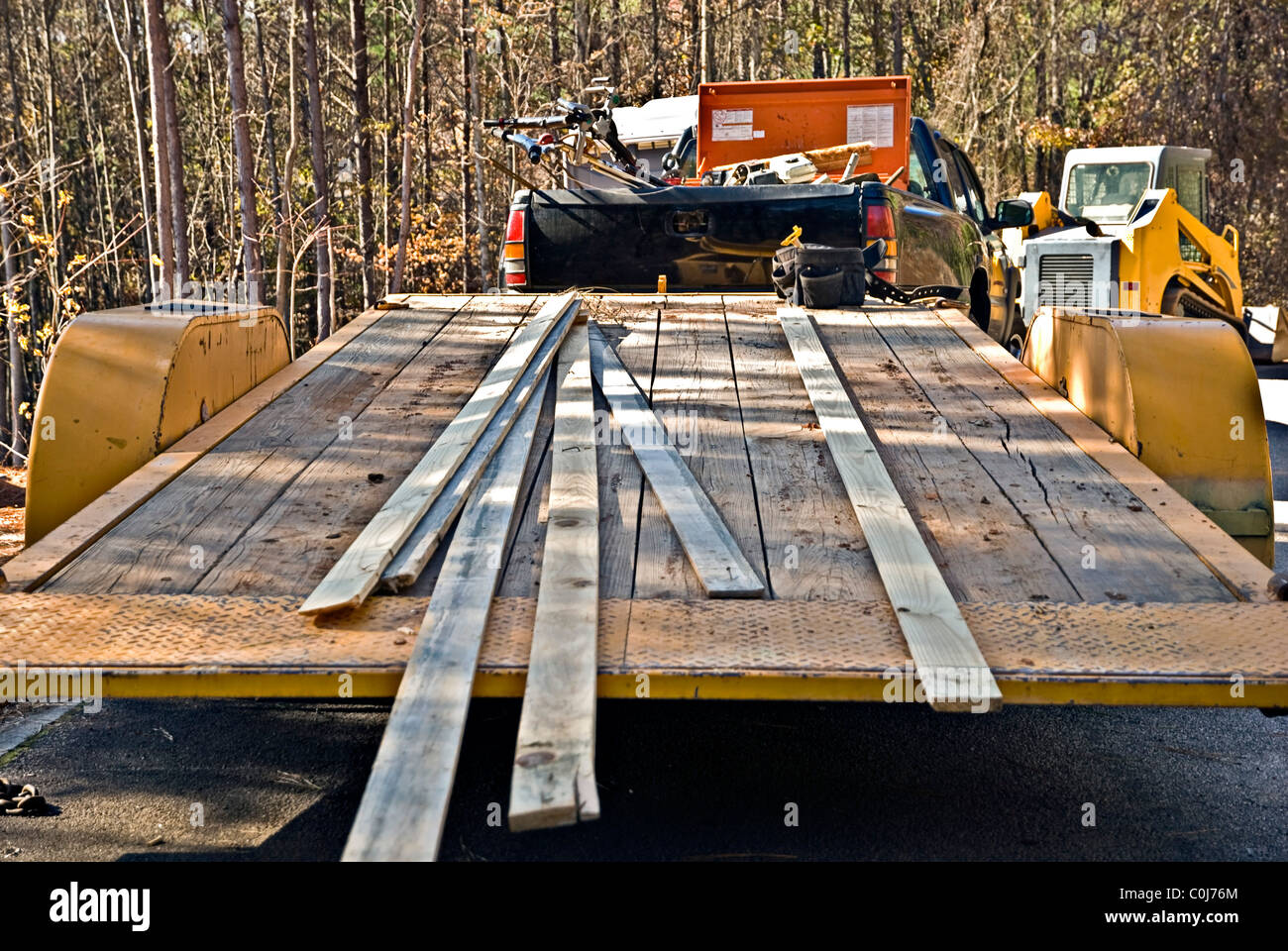 A truck, trailer, and other equipment at a construction site Stock ...