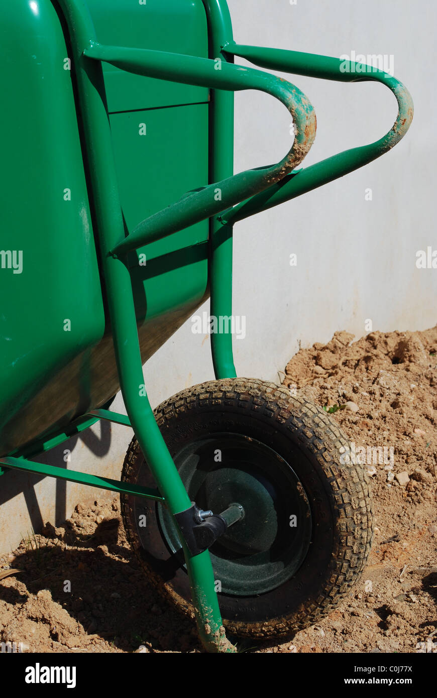Green wheelbarrow on a small farm Stock Photo - Alamy