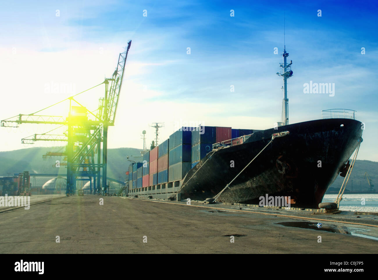 unloading of cargo ship in a port Stock Photo - Alamy