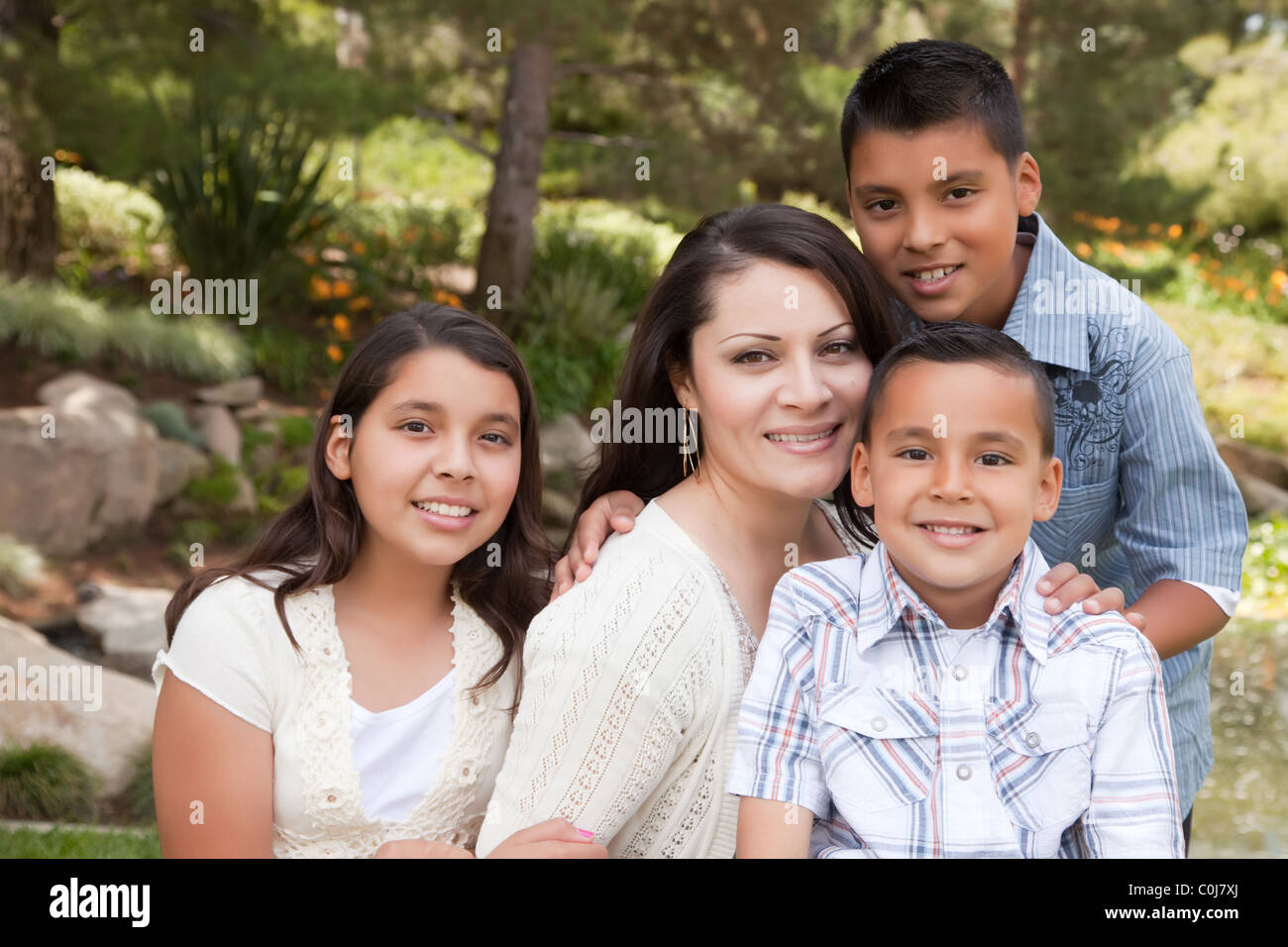 Happy Hispanic Mother and Children in the Park Stock Photo - Alamy